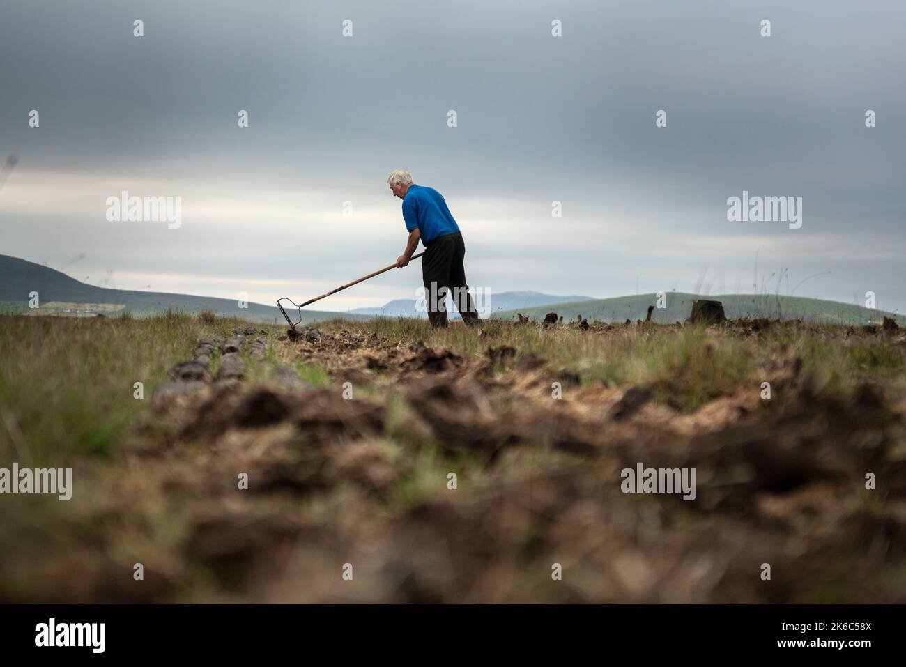 Aughness, Ballycroy, county Mayo, Ireland, 6-28-2019. Turning the turf ...