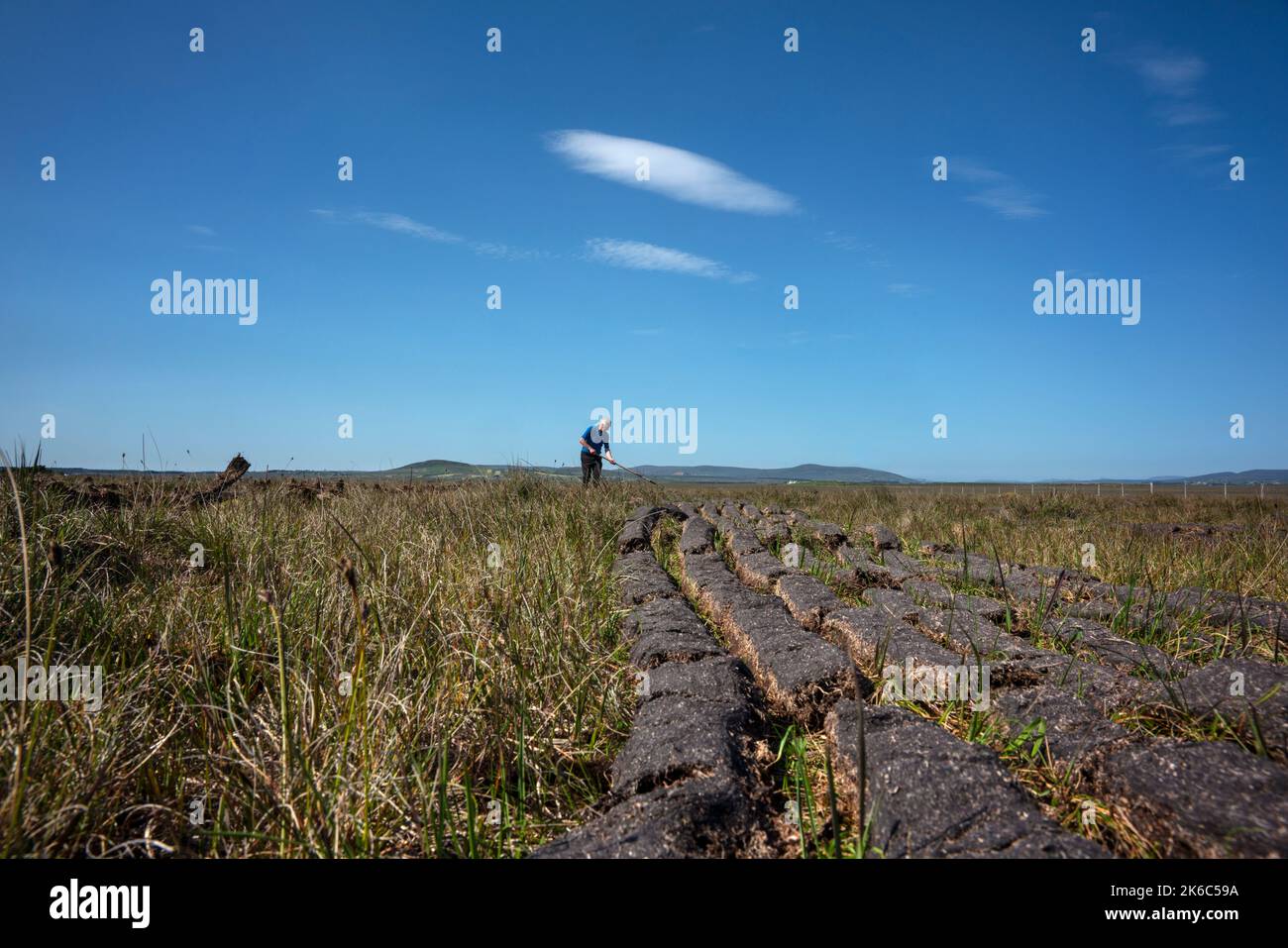 Aughness, Ballycroy, county Mayo, Ireland, 6-27-2019. Turning the turf ...