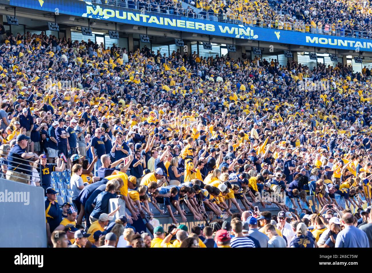 The football fans in the stadium at a West Virginia University college ...