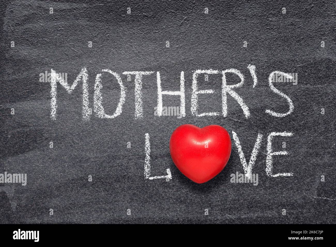 mother's love phrase written on chalkboard with red heart symbol ...