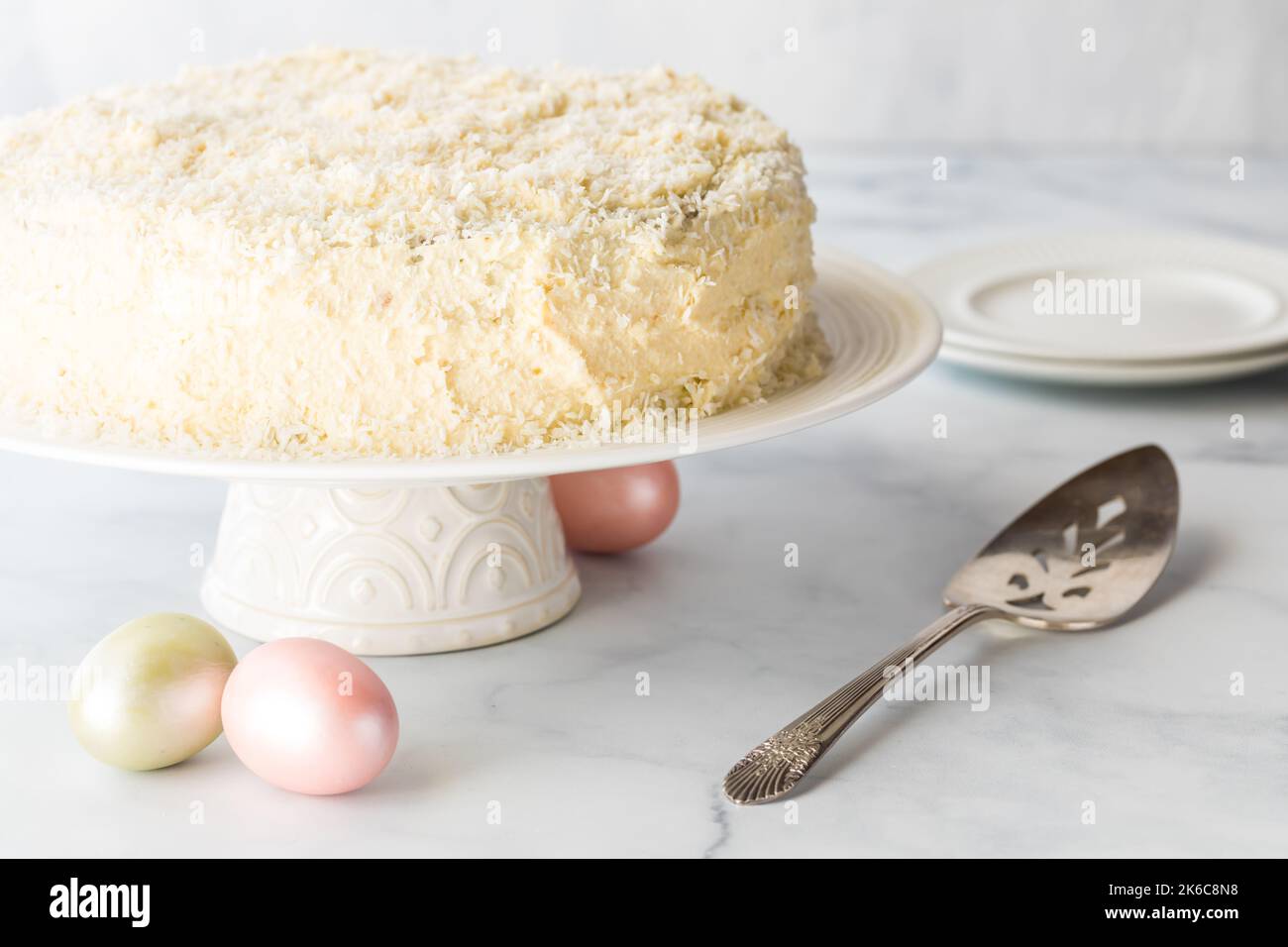 A creamy white frosted coconut covered cake for Easter, ready for ...