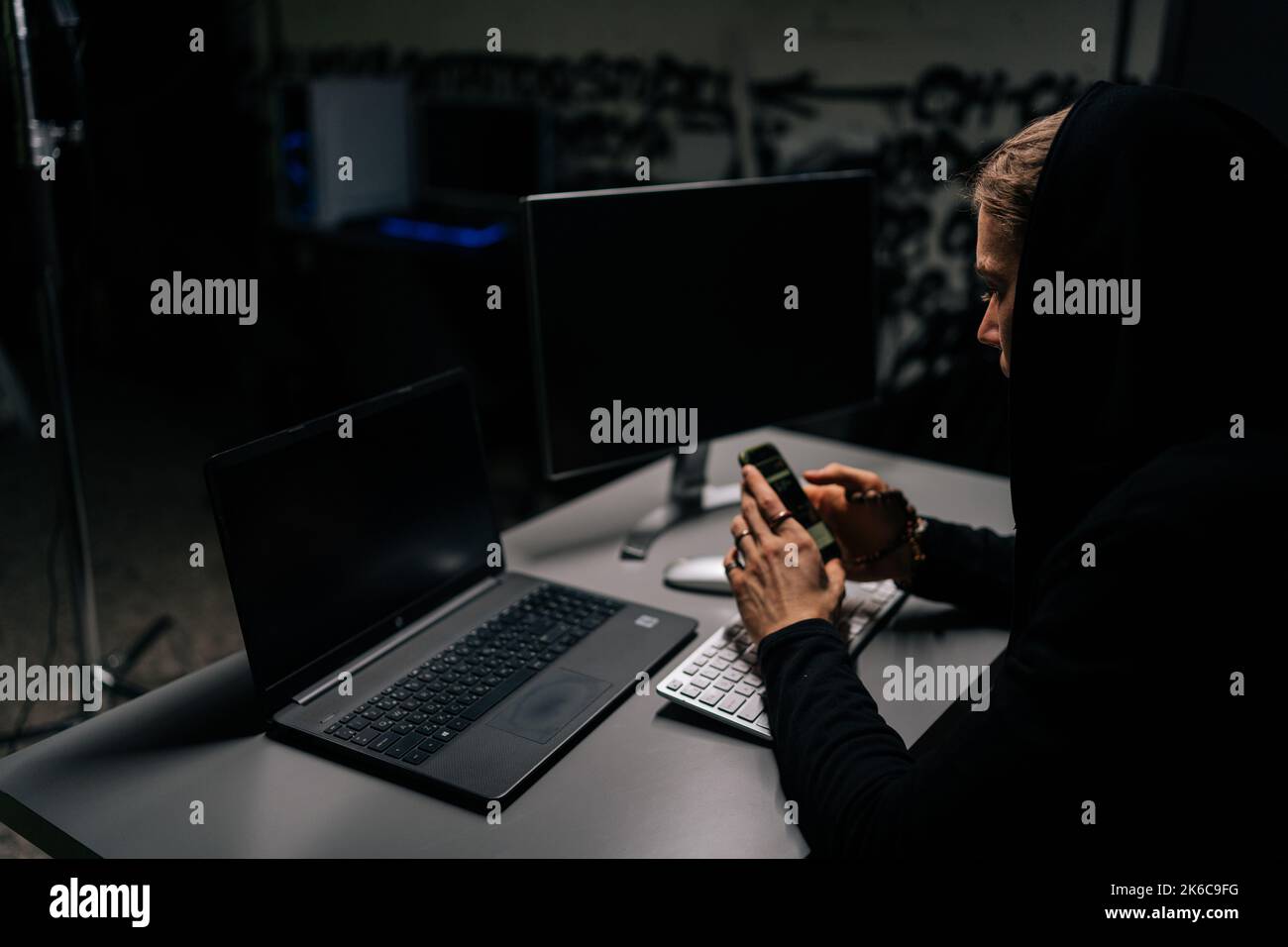 View From Back To Hidden Hacker Man Wearing Sweatshirt With Hood