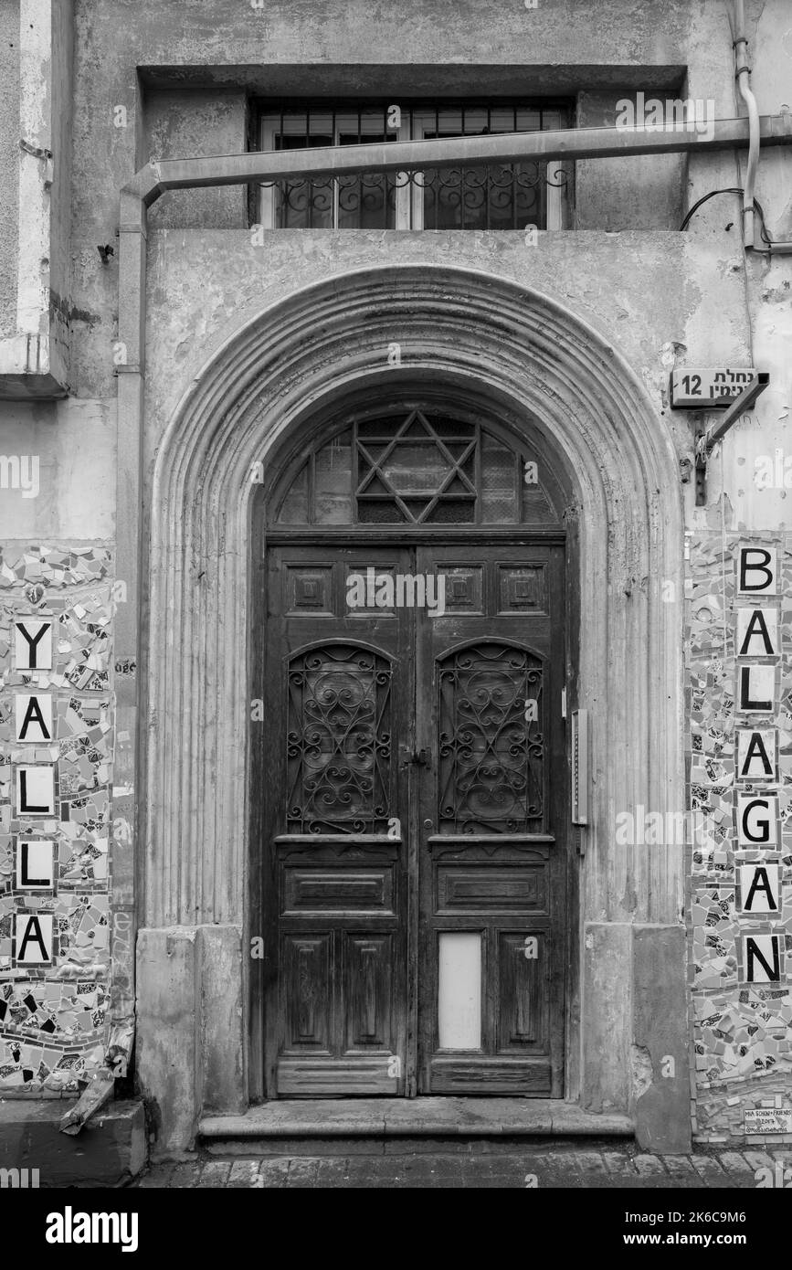 A grayscale shot of the Yalla Balagan (Hebrew) on the building entrance ...