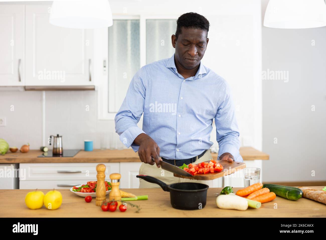 Man preparing food at home Stock Photo - Alamy