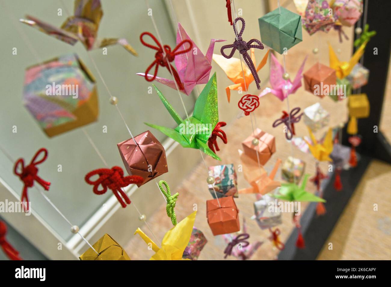 Japanese art installation made of paper cranes, ribbons and boxes Stock ...