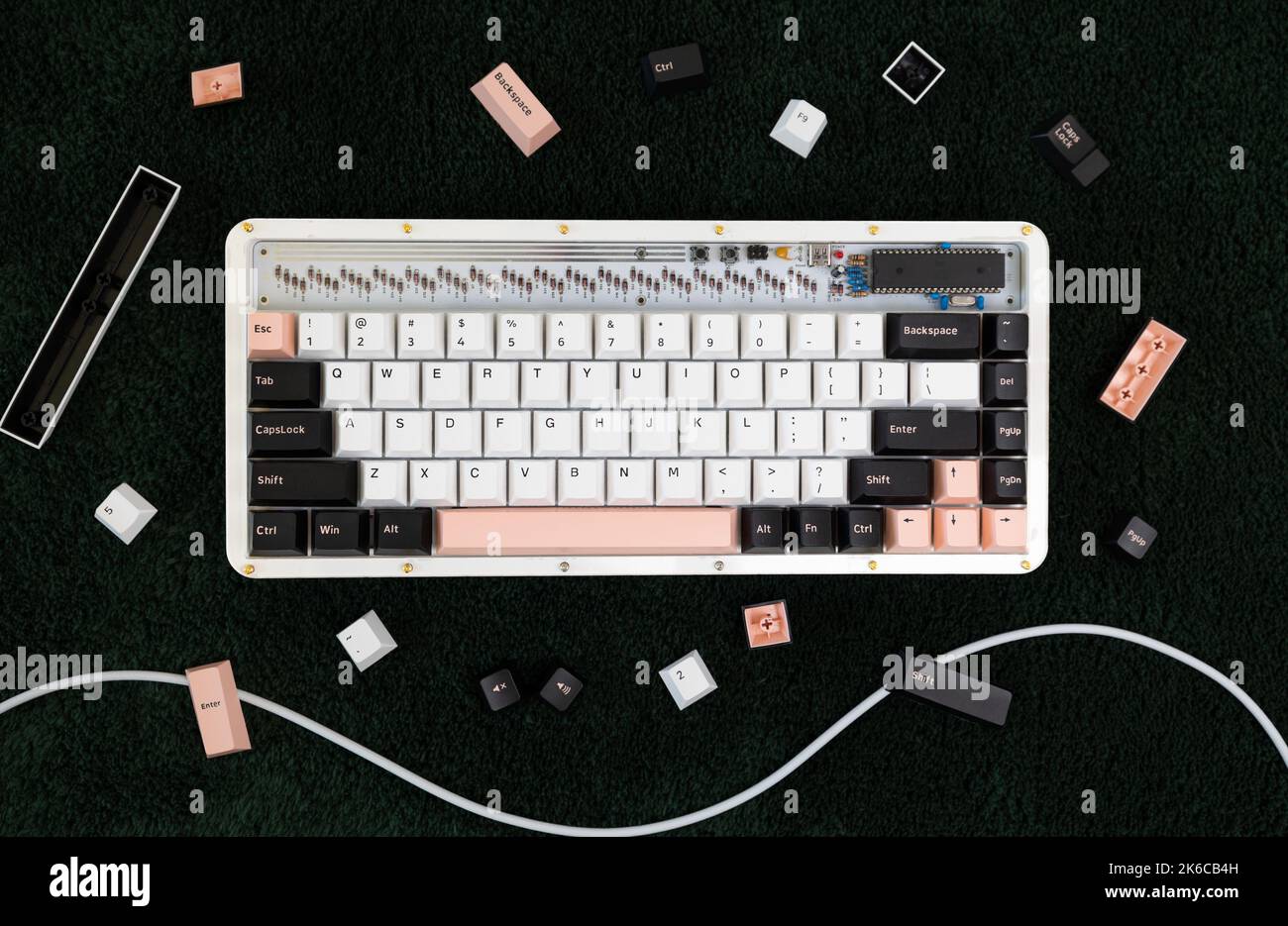 A top view of a decorative customizable keyboard with pink, black, and ...