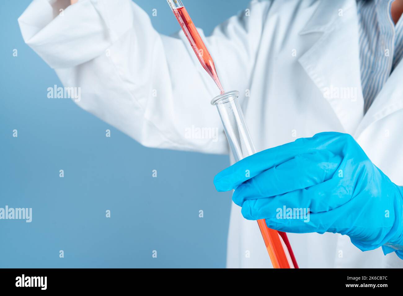 Young scientist with test tube making research in clinical laboratory ...