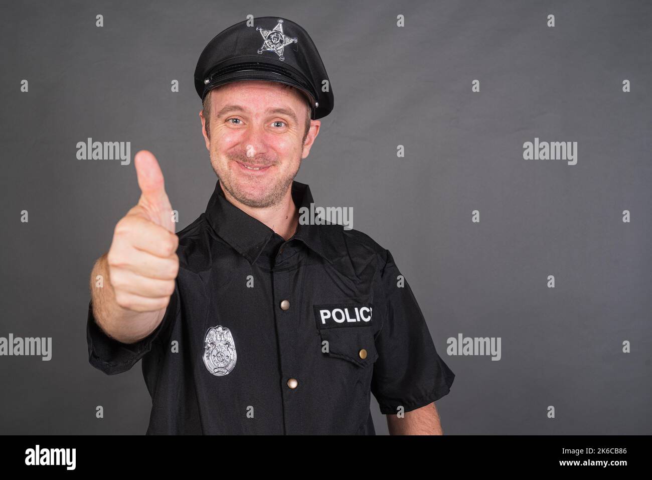 Portrait of happy Caucasian man wearing police uniform costume and ...