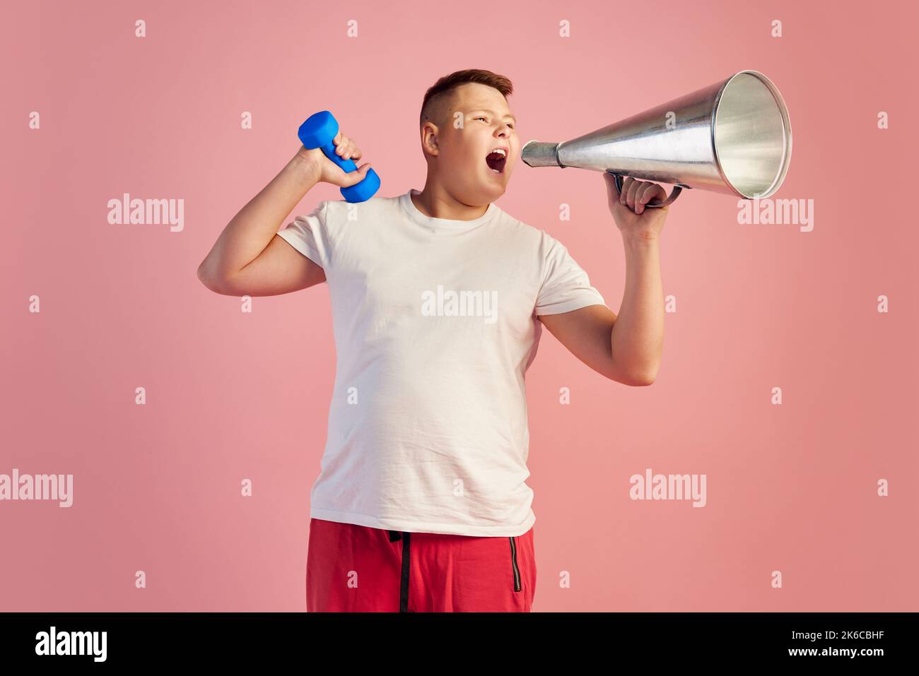 Attention, news. Excited young boy shouting at megaphone isolated on ...