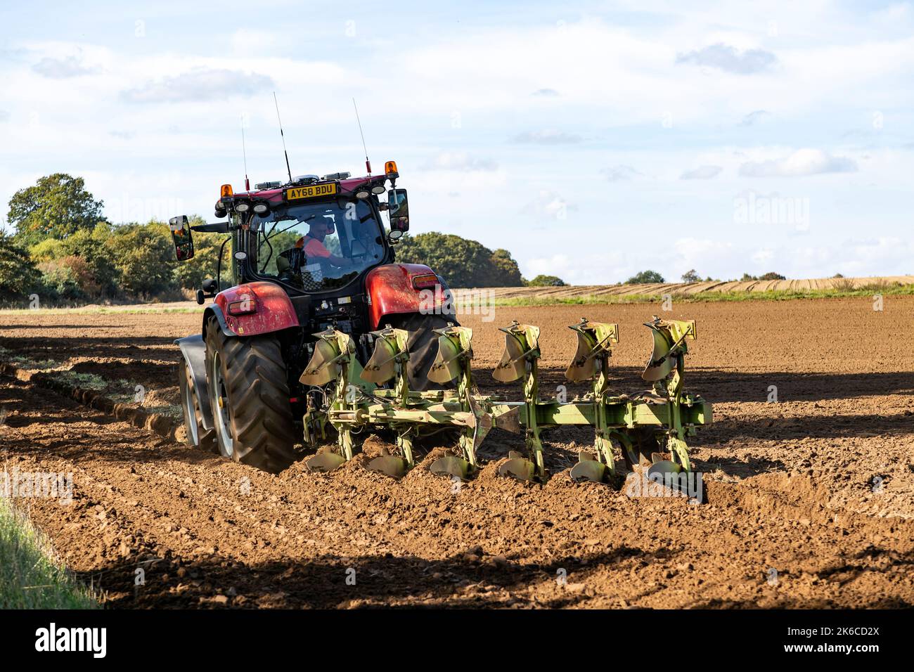 CASE 220 red tractor ploughing field six-furrow plough, Suffolk ...
