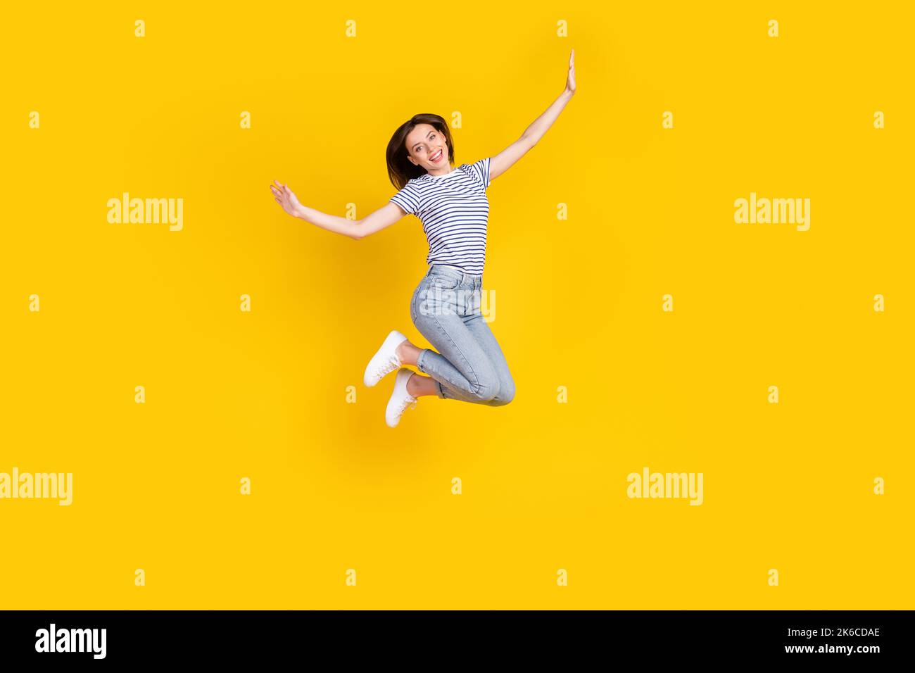 Full Length Photo Of Nice Young Girl Spread Hands Plane Jumping Ad Poster Wear Stylish Striped
