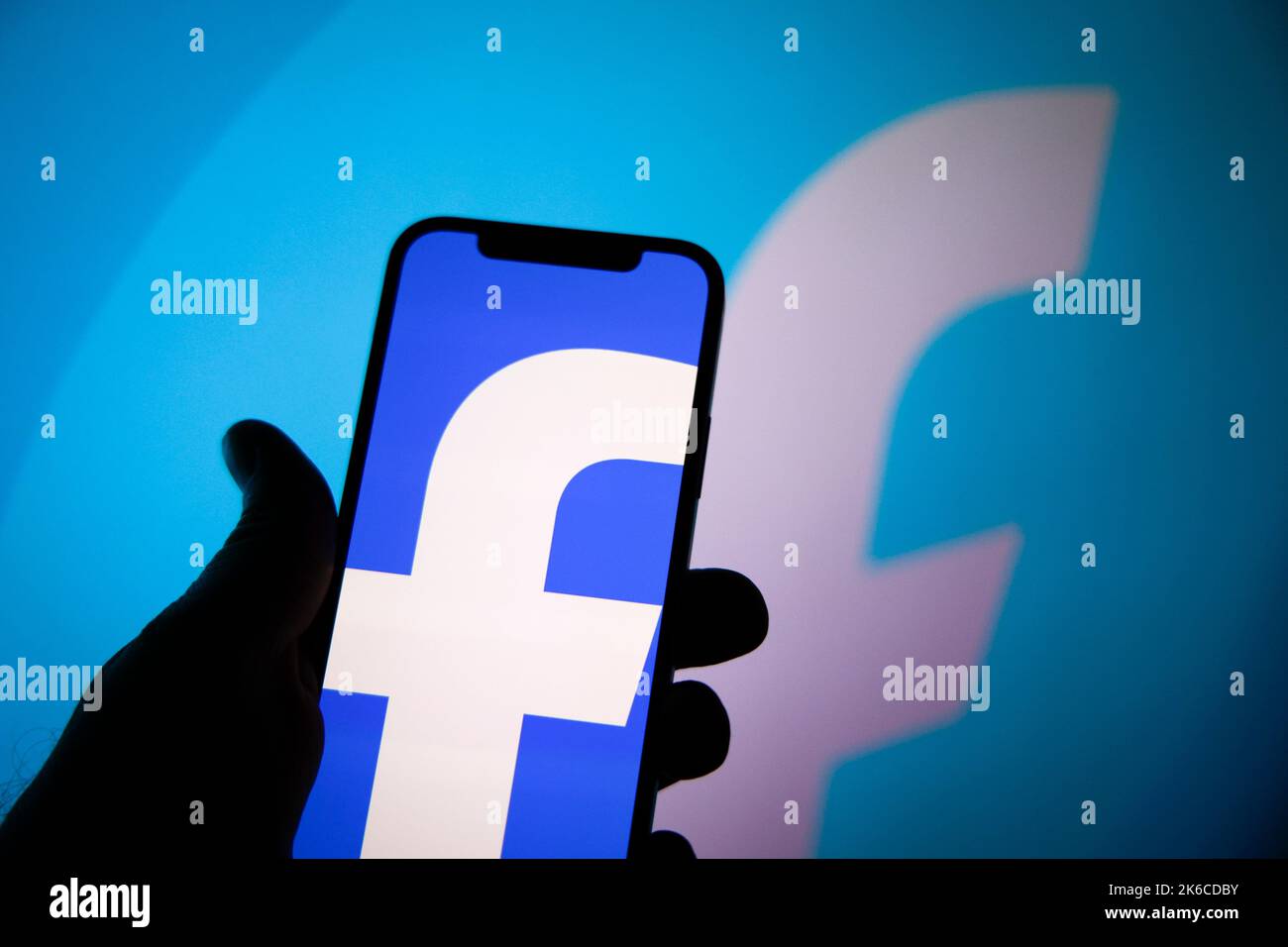 The Facebook logo is seen on an iPhone mobile device in this ...