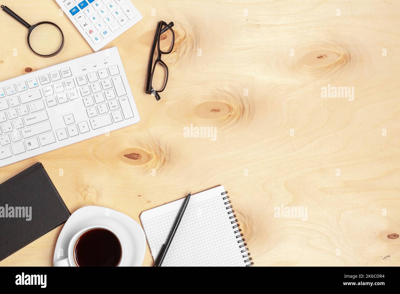 Office table with note paper, computer keyboard and supplies close up ...