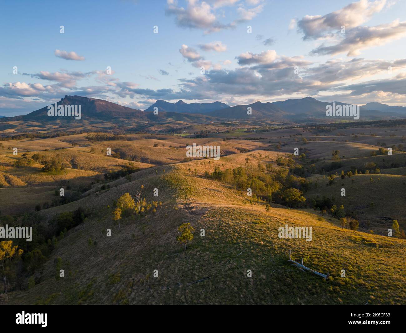 Picturesque rolling hills in the countryside with dramatic mountains as ...