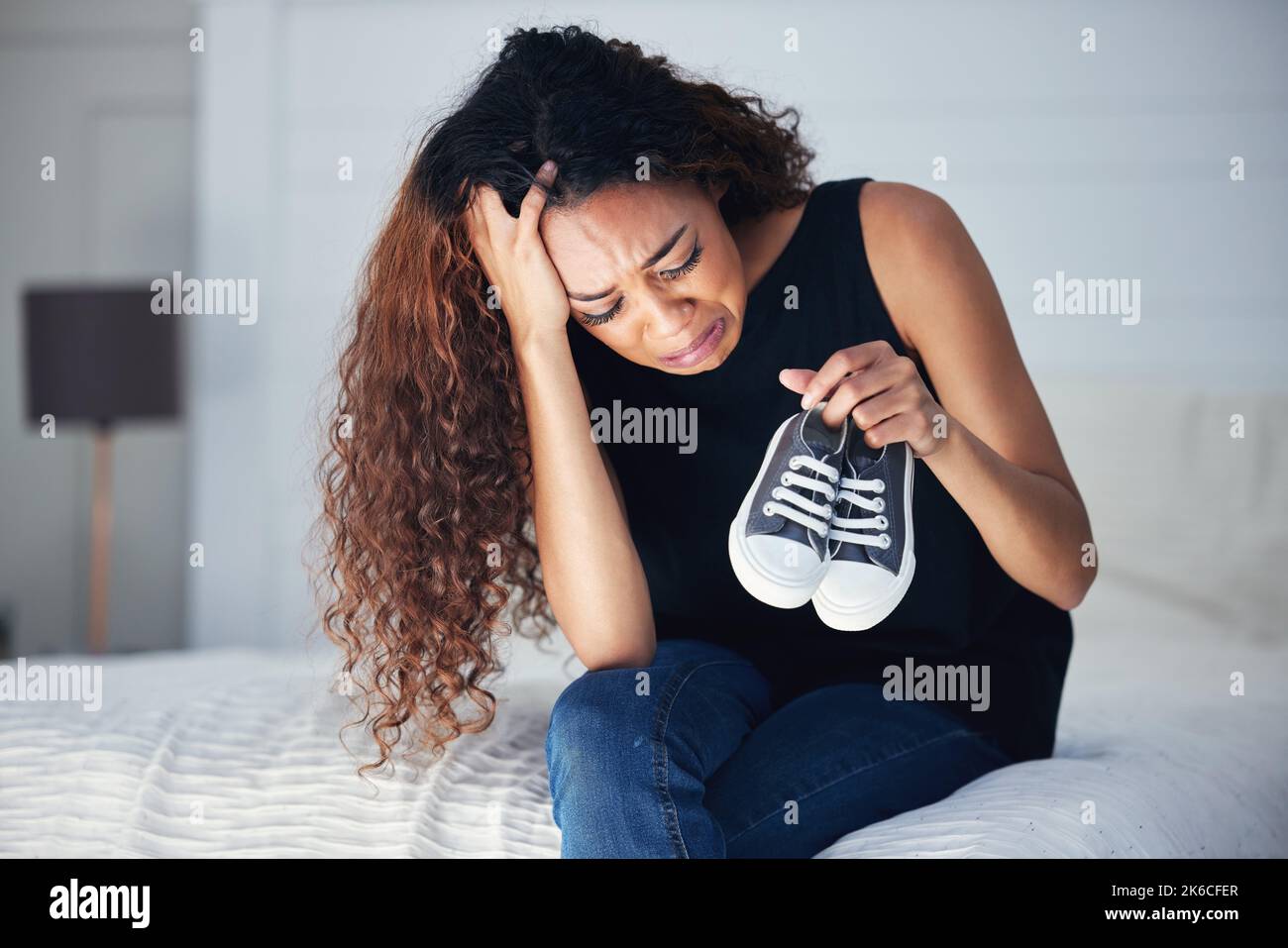 I cant believe this is real. a young woman looking sad while holding a ...