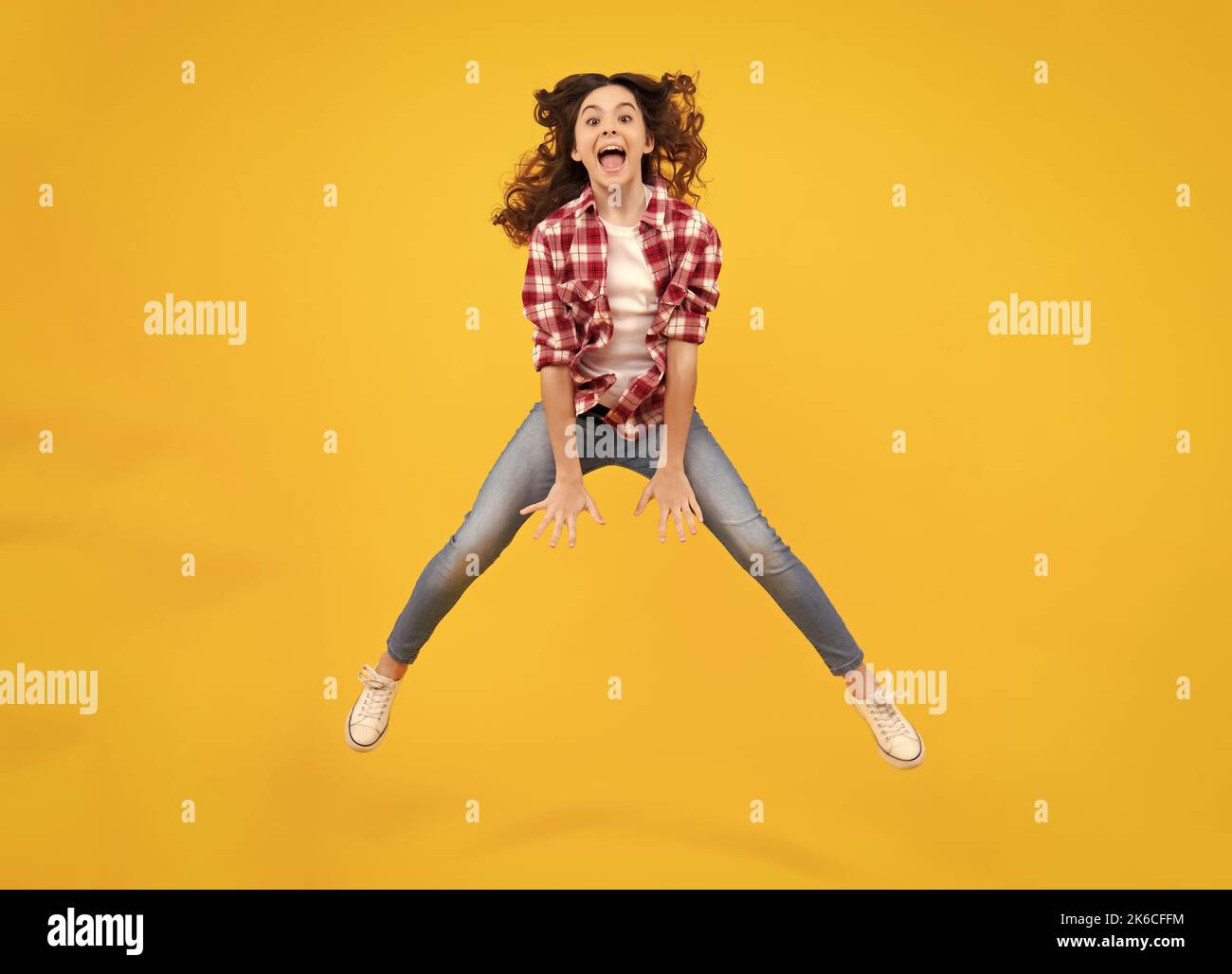 Amazed teenager. Happiness, activity and child. Teenager girl jumping ...