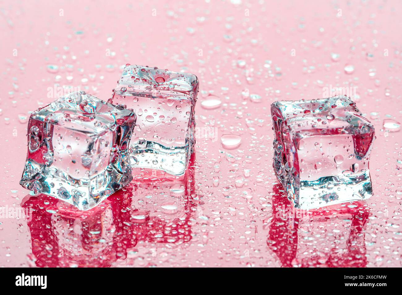 Ice cubes on pink background Stock Photo - Alamy