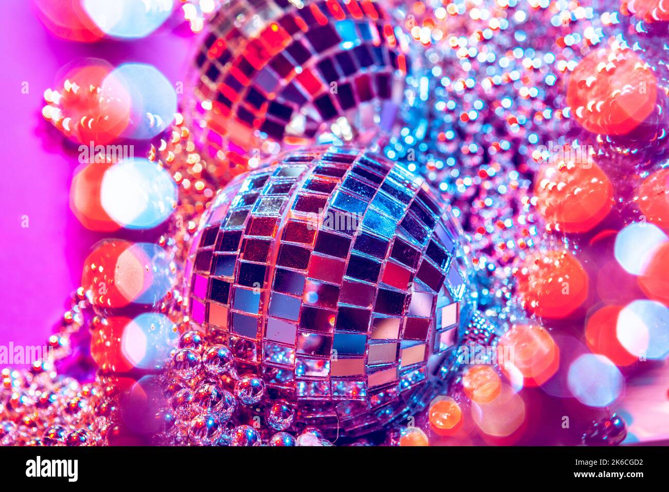 Shiny small disco balls sparkling in a beautiful purple light. Disco ...
