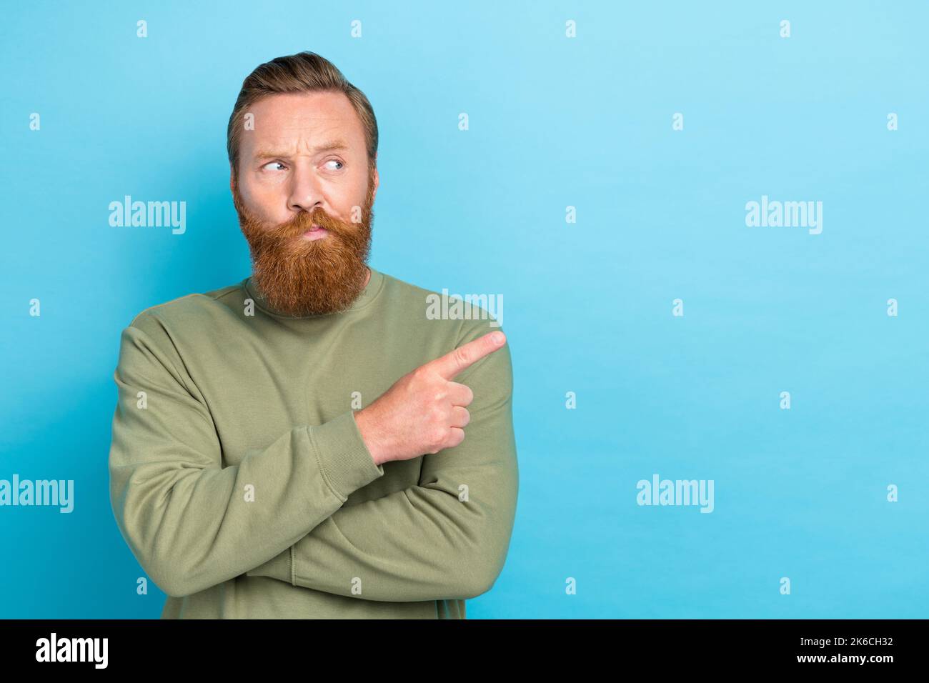 Photo of unsatisfied man with red hairstyle dressed khaki long sleeve ...