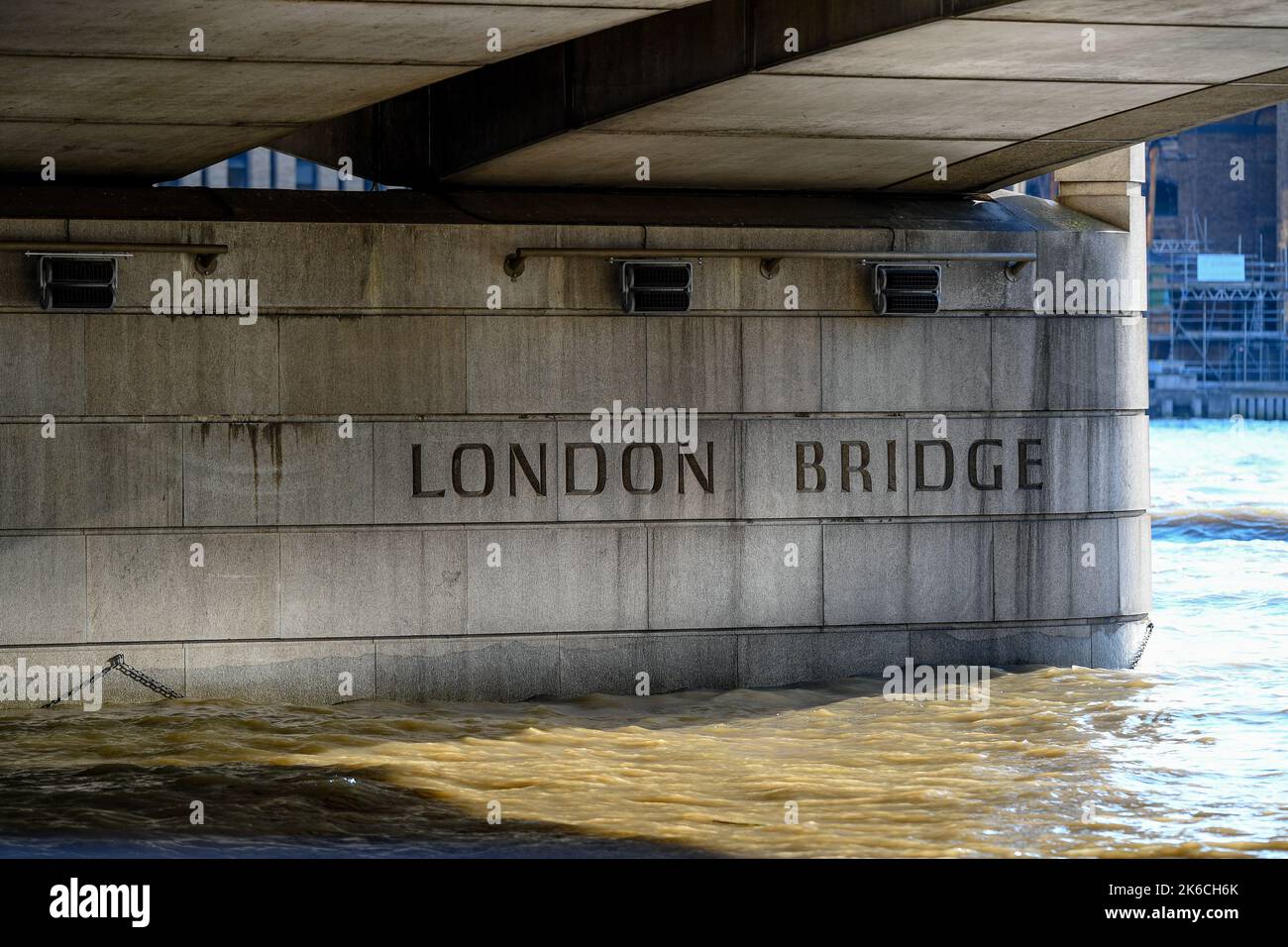 A close-up of the carved lettering underneath London Bridge bathed in ...