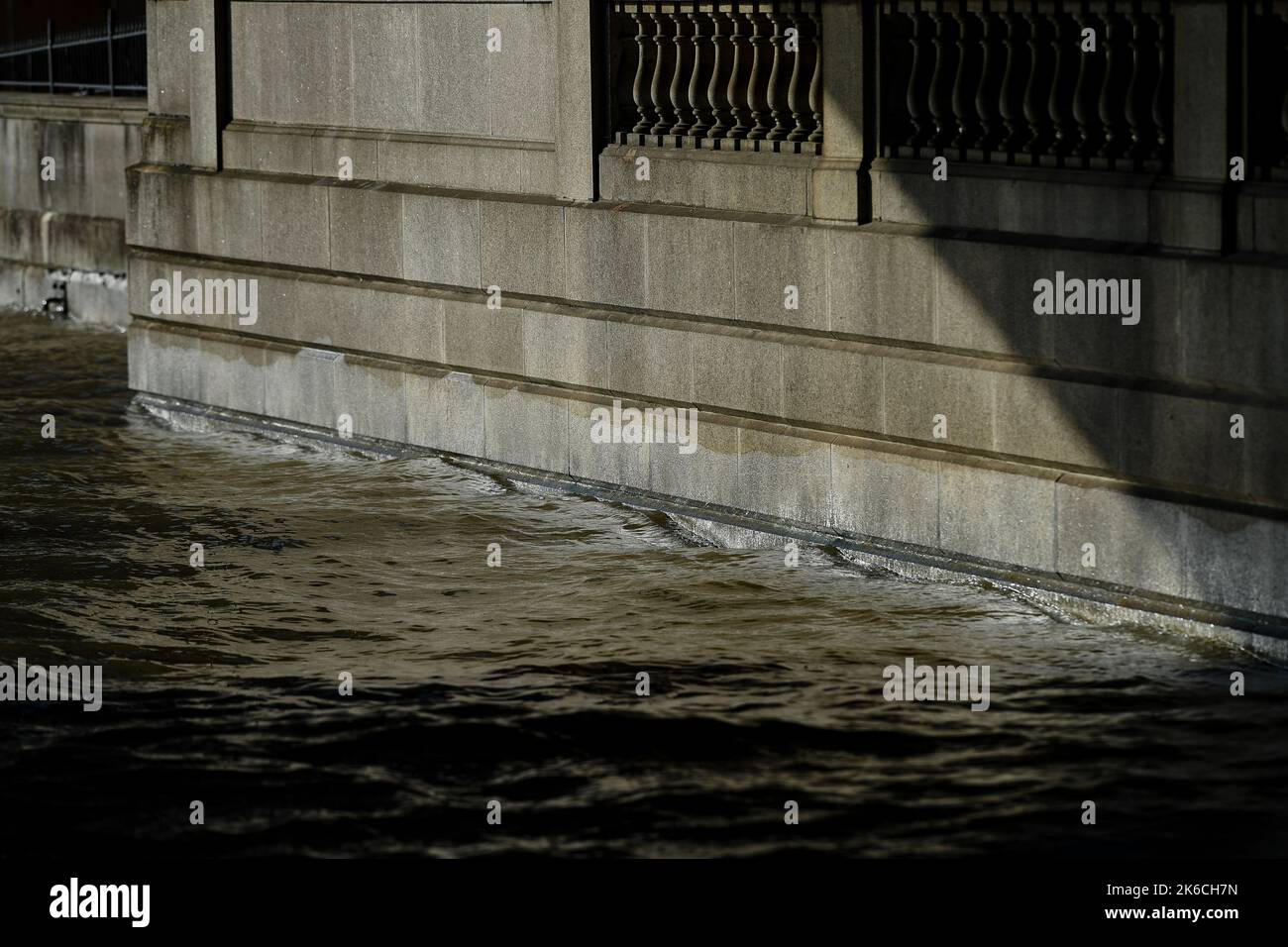The river Thames at high tide lapping against the walls under London ...