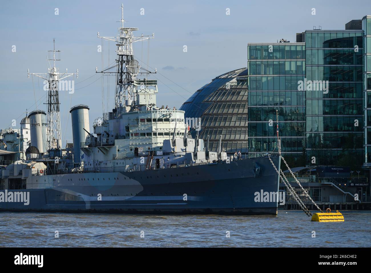 A telephoto view of HMS Belfast moored on River Thames with modern ...