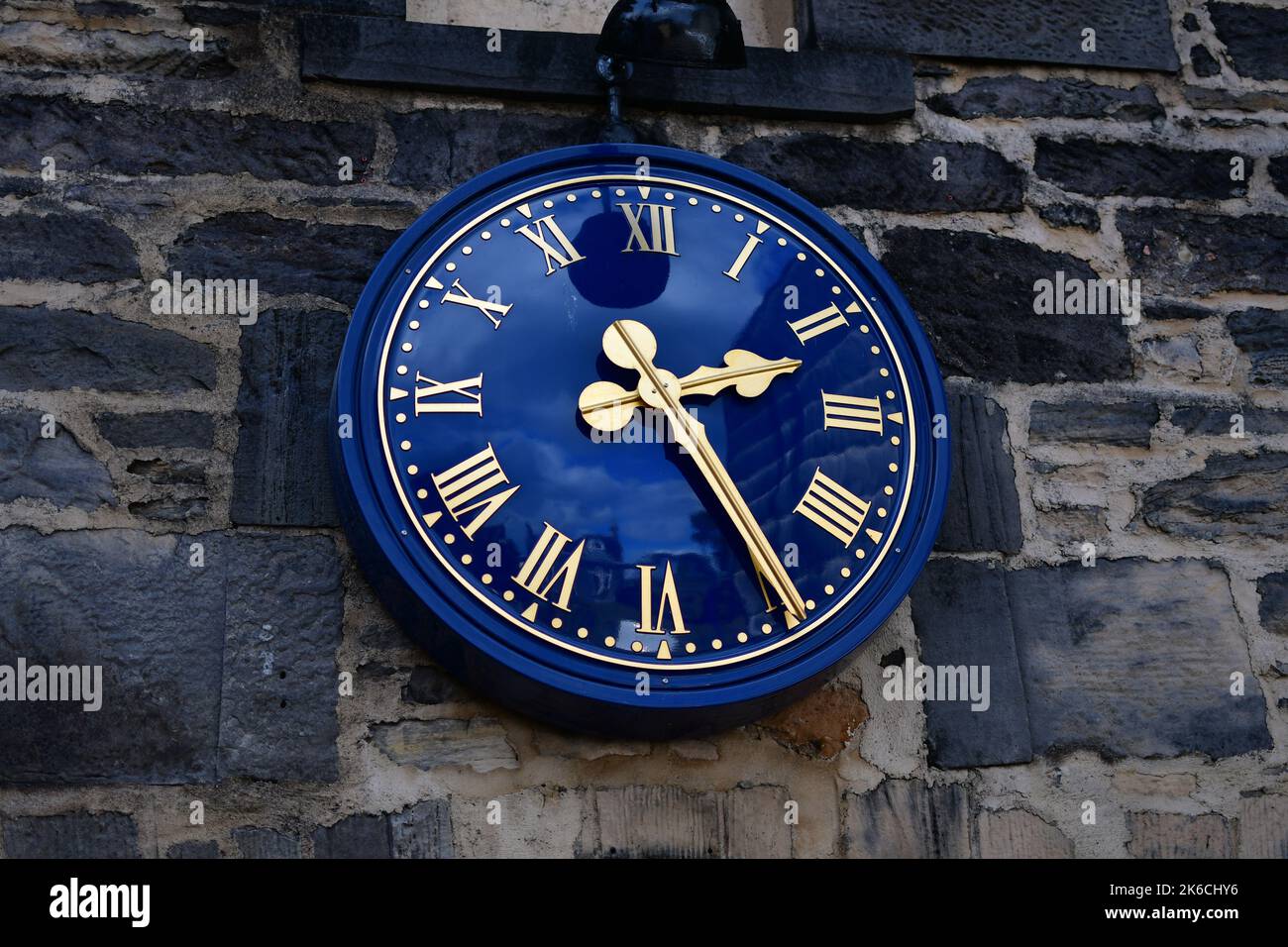 A blue enamel clock on a building wall Stock Photo - Alamy