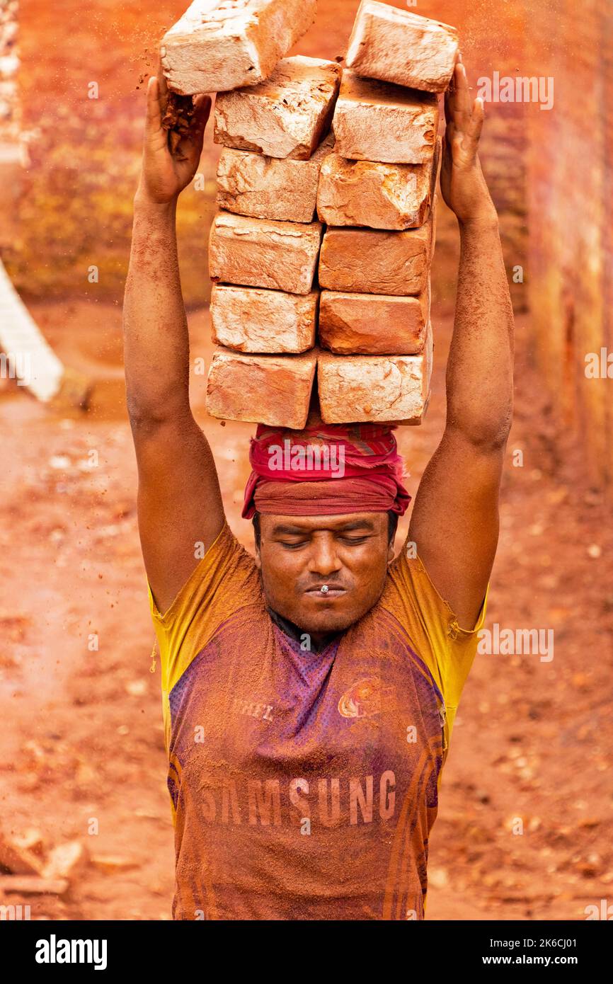 October 13, 2022, Dhaka, Bangladesh: Workers carry piles of bricks ...