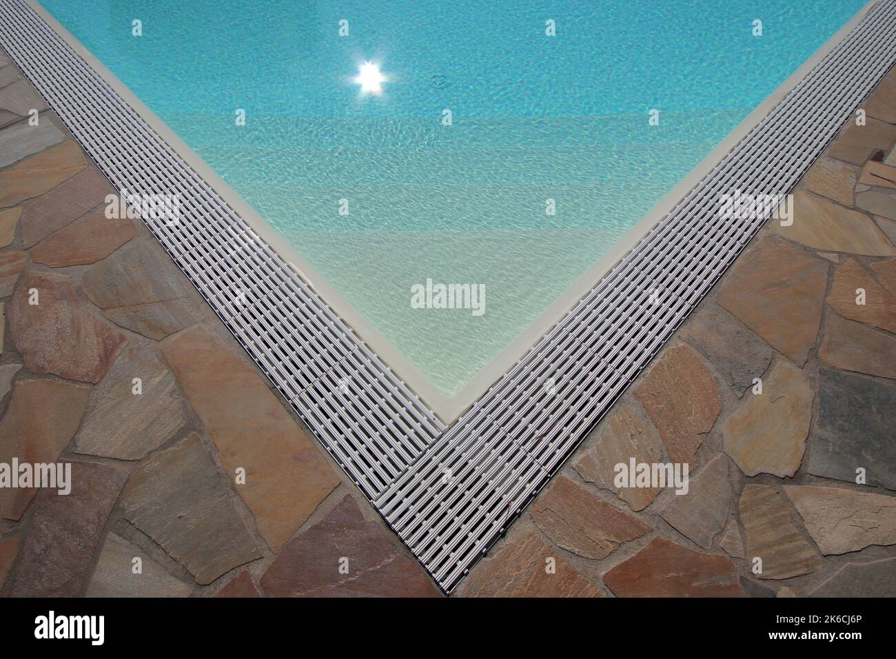 Summer swimming pool with blue water and sun reflection Stock Photo - Alamy
