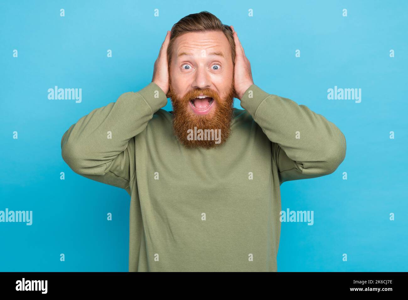 Photo portrait of handsome young guy arms touch head impressed cant ...