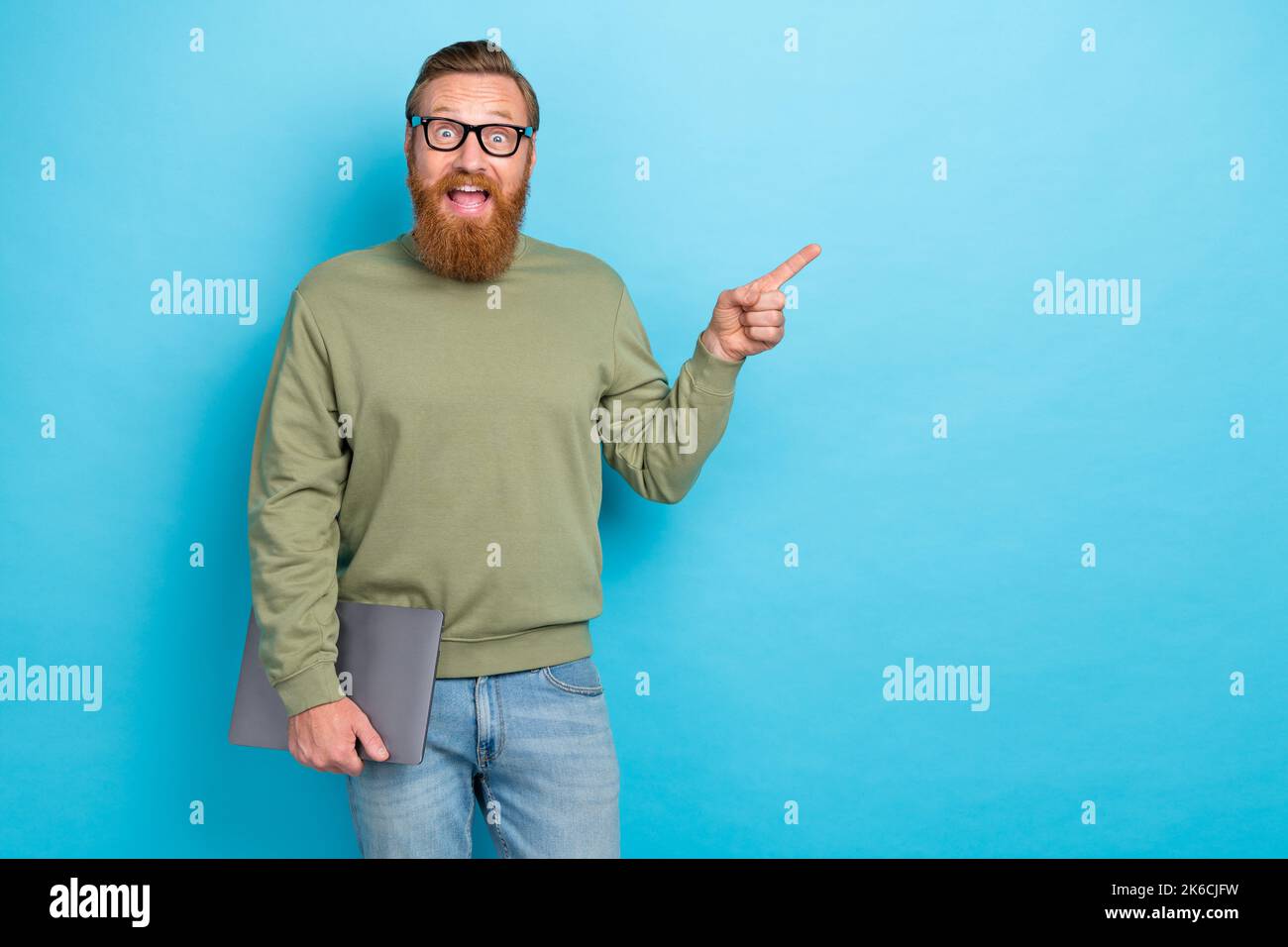 Photo portrait of attractive young guy finger point copyspace excited ...