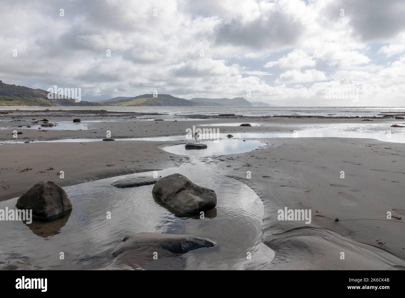 rock pools on a beautiful deserted sandy beach in Lyme Regis Dorset ...