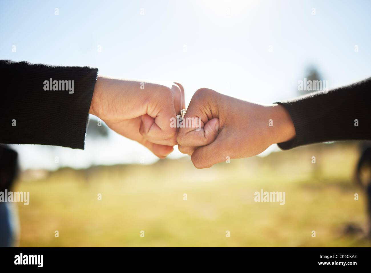 Guide us through this realm. two people fist bumping on another Stock ...