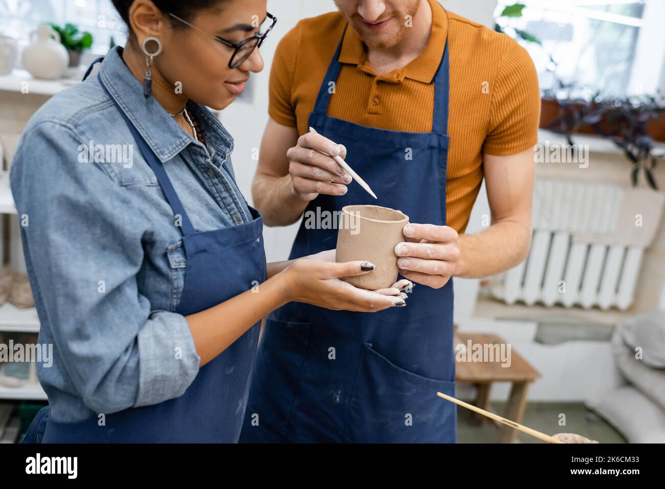 african american woman in eyeglasses looking at bearded redhead man ...