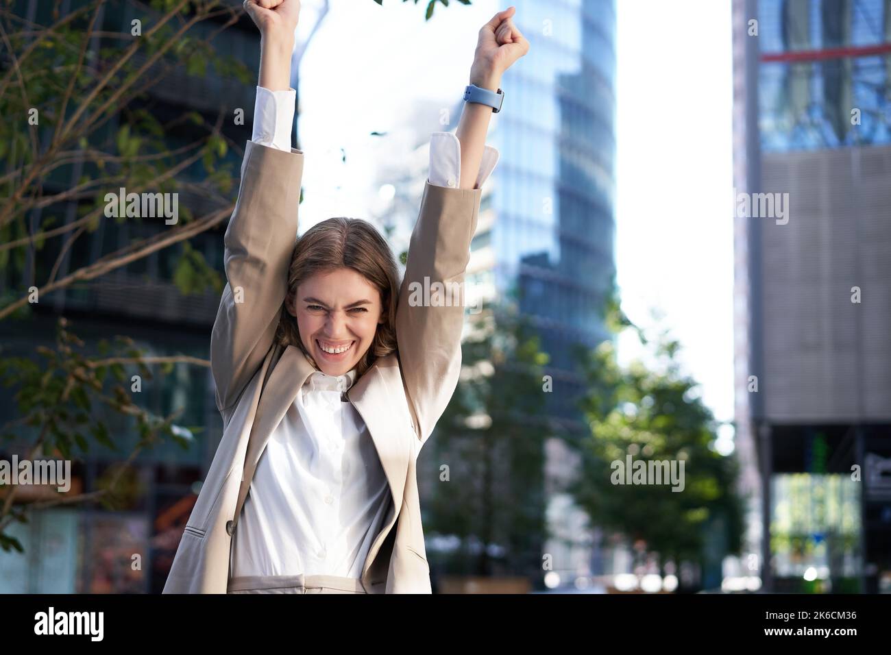Saleswoman expresses joy and happiness. Businesswoman triumphing on ...
