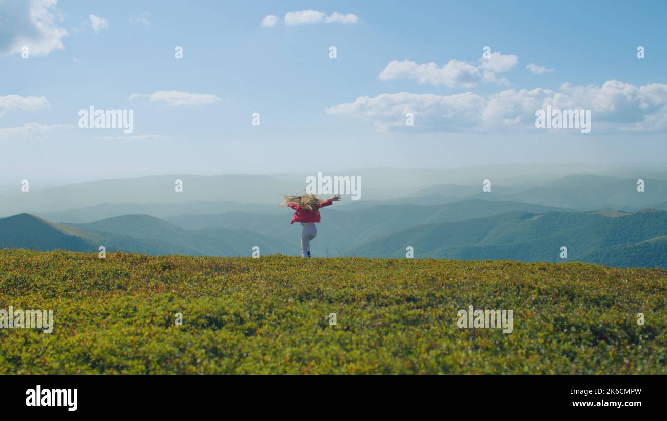 Young girl moves long hair, spinning around itself on beautiful ...