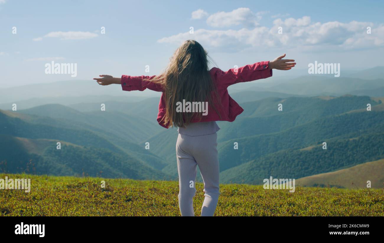 Young girl moves long hair, spinning around itself on beautiful ...