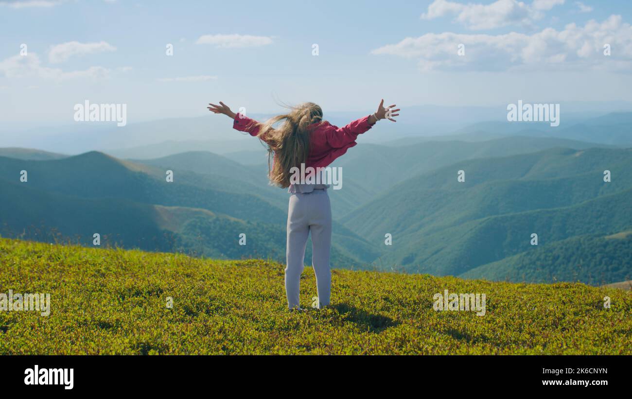 Young girl moves long hair, spinning around itself on beautiful ...