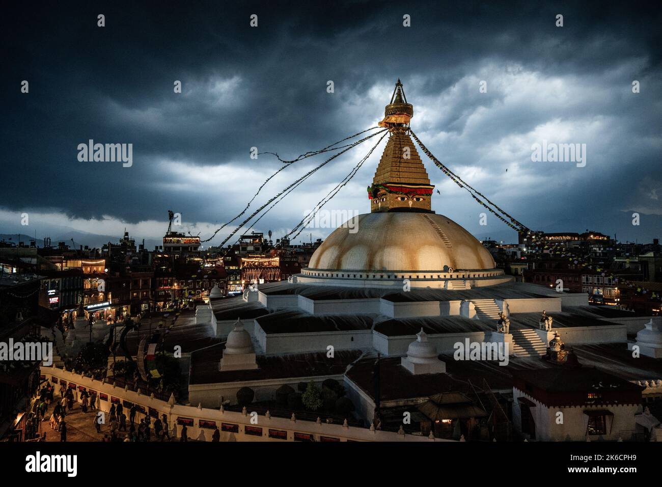 An aerial view of Boudhanath Stupa temple dome with prayer flags under ...