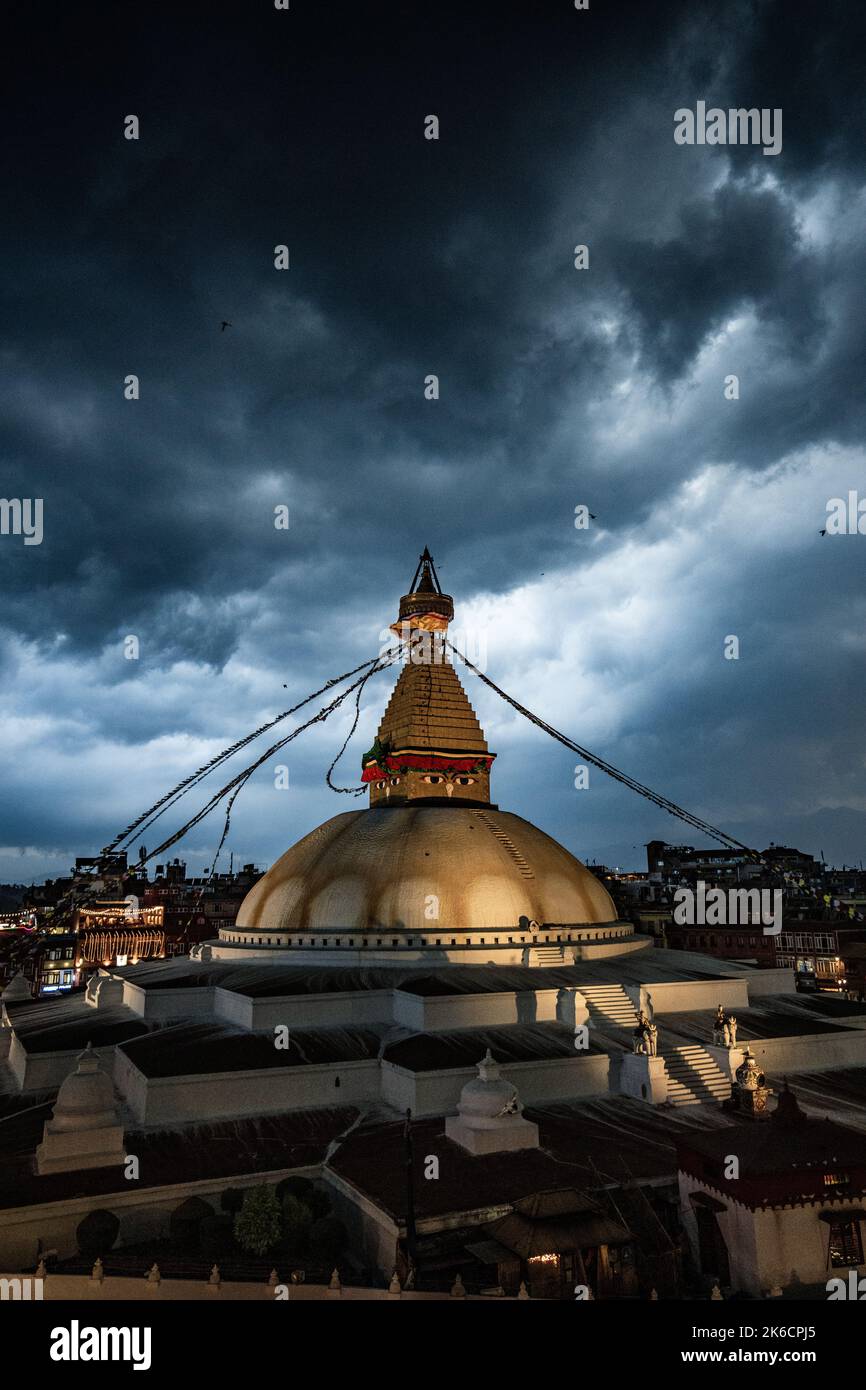 An aerial view of Boudhanath Stupa temple dome with prayer flags under ...