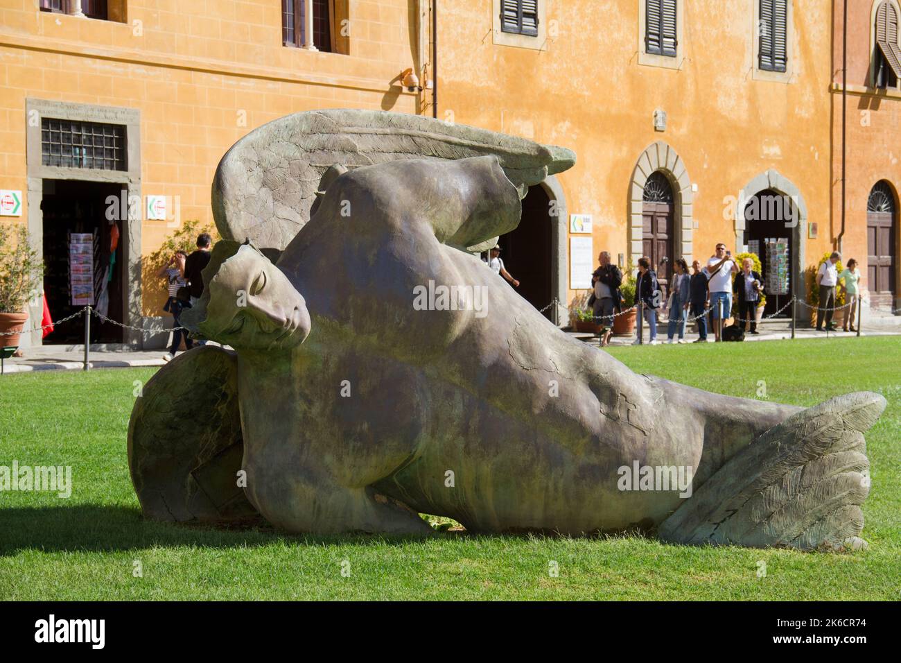 Fallen angel, bronze sculpture of an angel lying on its side in Pisa ...