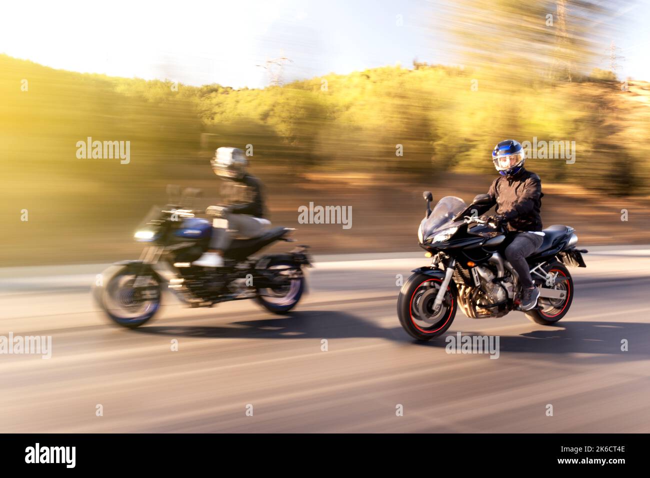 Two supersport race motorcycle riders going fast side by side on the ...