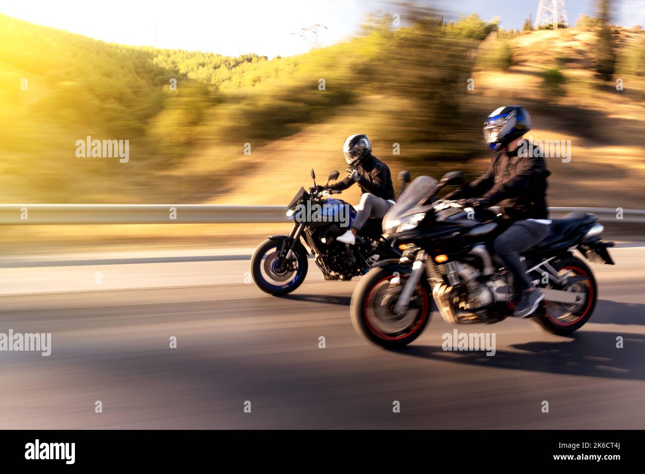 Two supersport race motorcycle riders going fast side by side on the ...