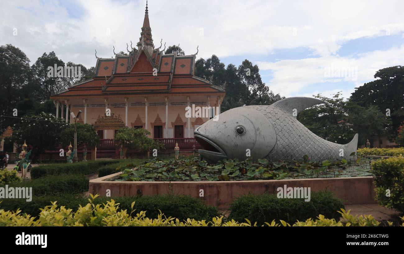 A giant fish sculpture on the water fountain with a palace background ...