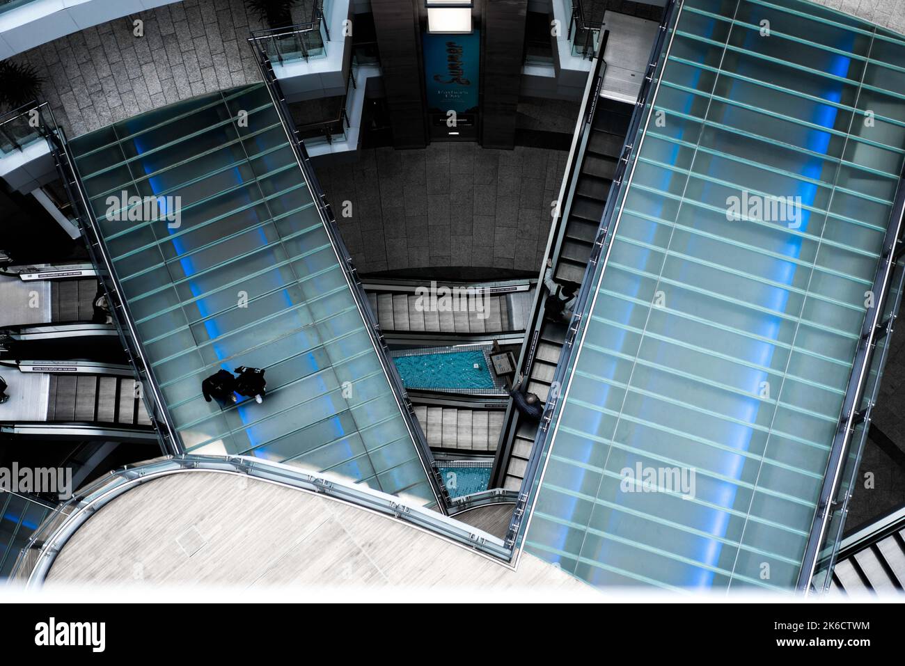 A top view of people walking on a glass bridge near the buildings Stock ...