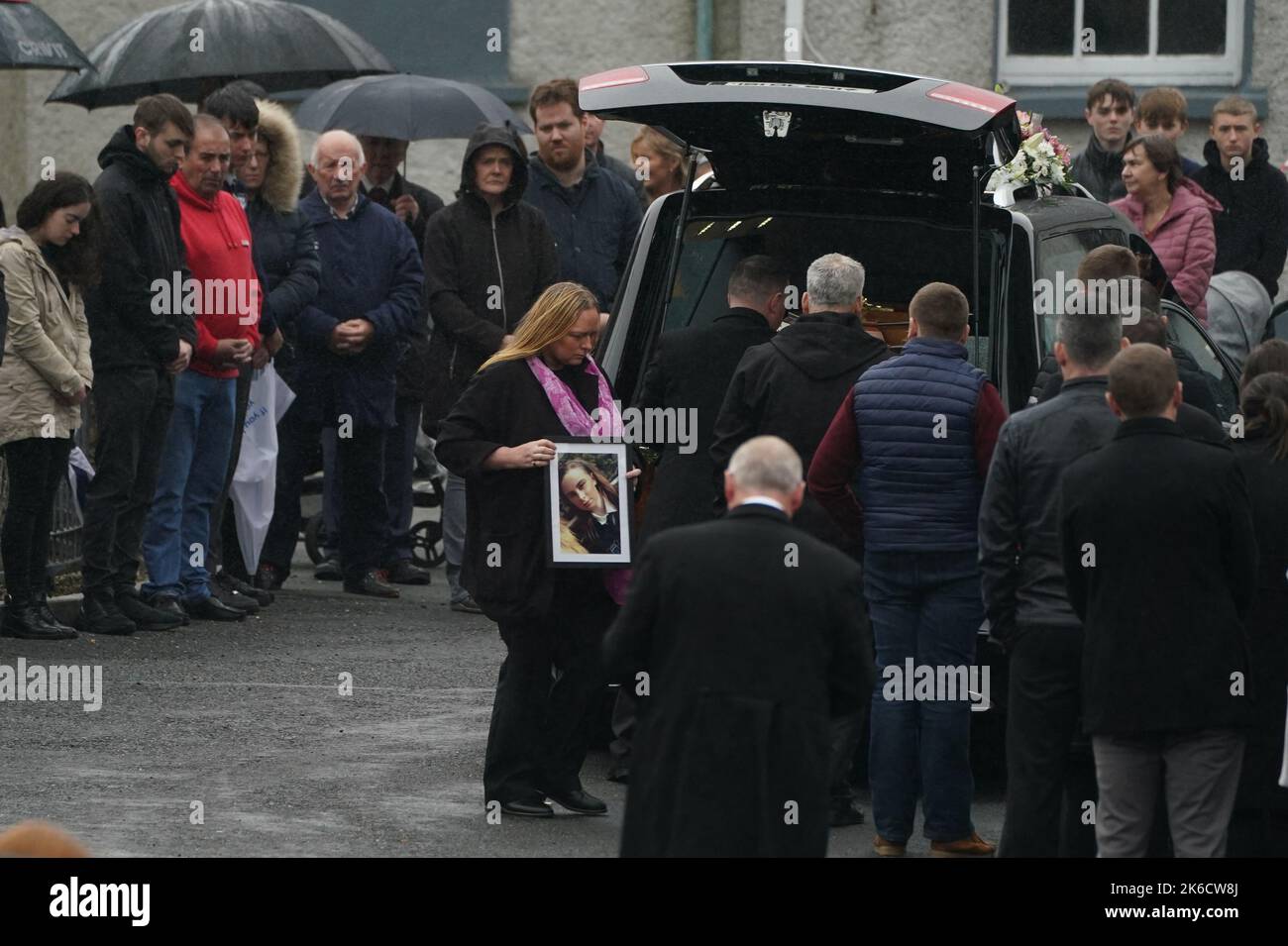 Leona Harper's mother Donna carries a photo of her as her coffin ...