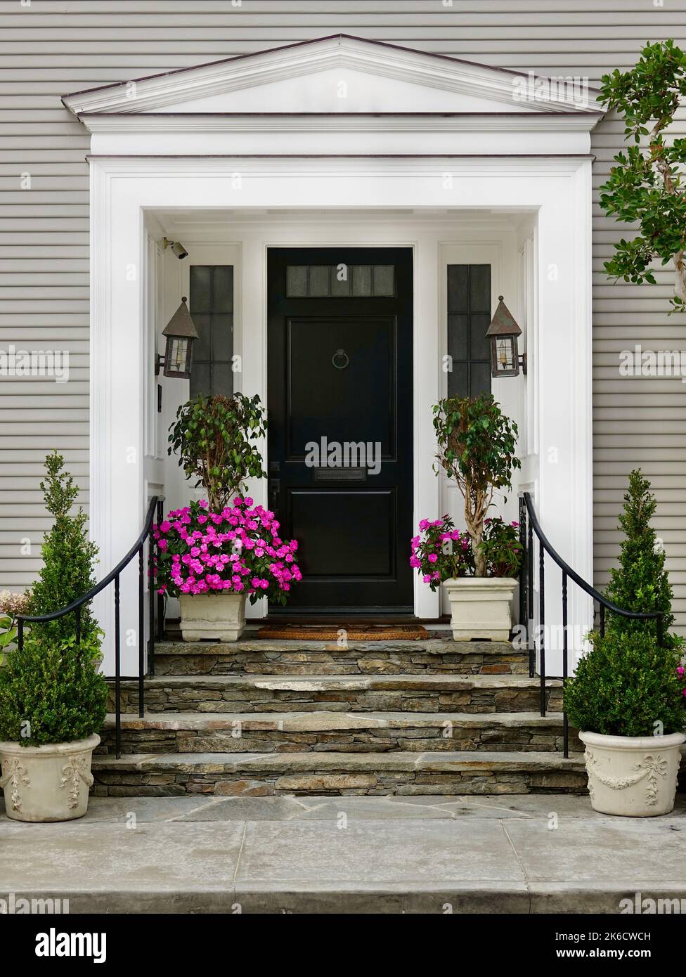 entrance to traditional home with flagstone steps and metal railing ...