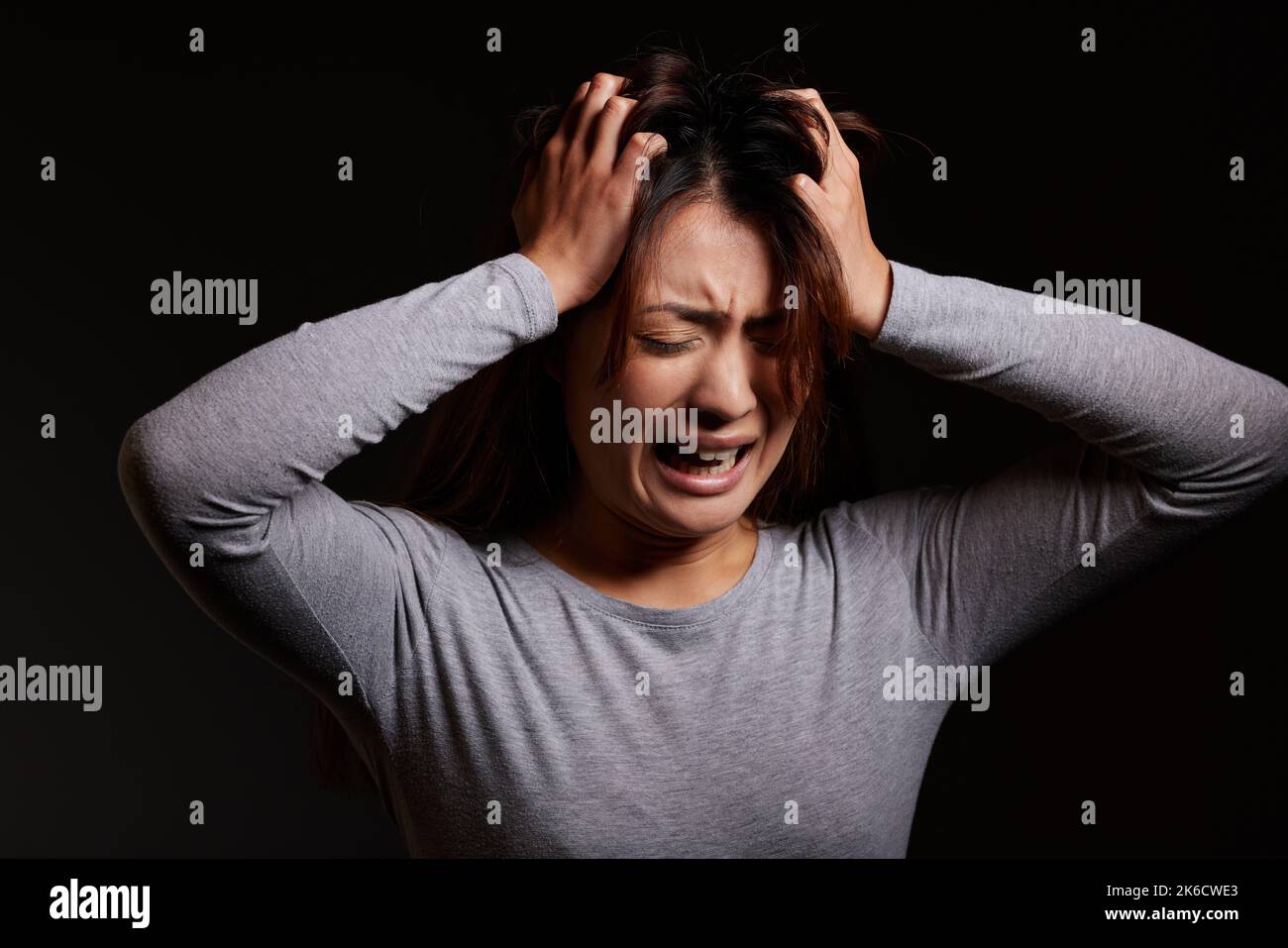 Am I crazy. a young woman experiencing mental illness against a black ...