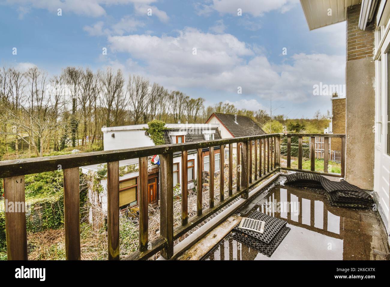 Narrow brick balcony with wooden railings and door Stock Photo - Alamy