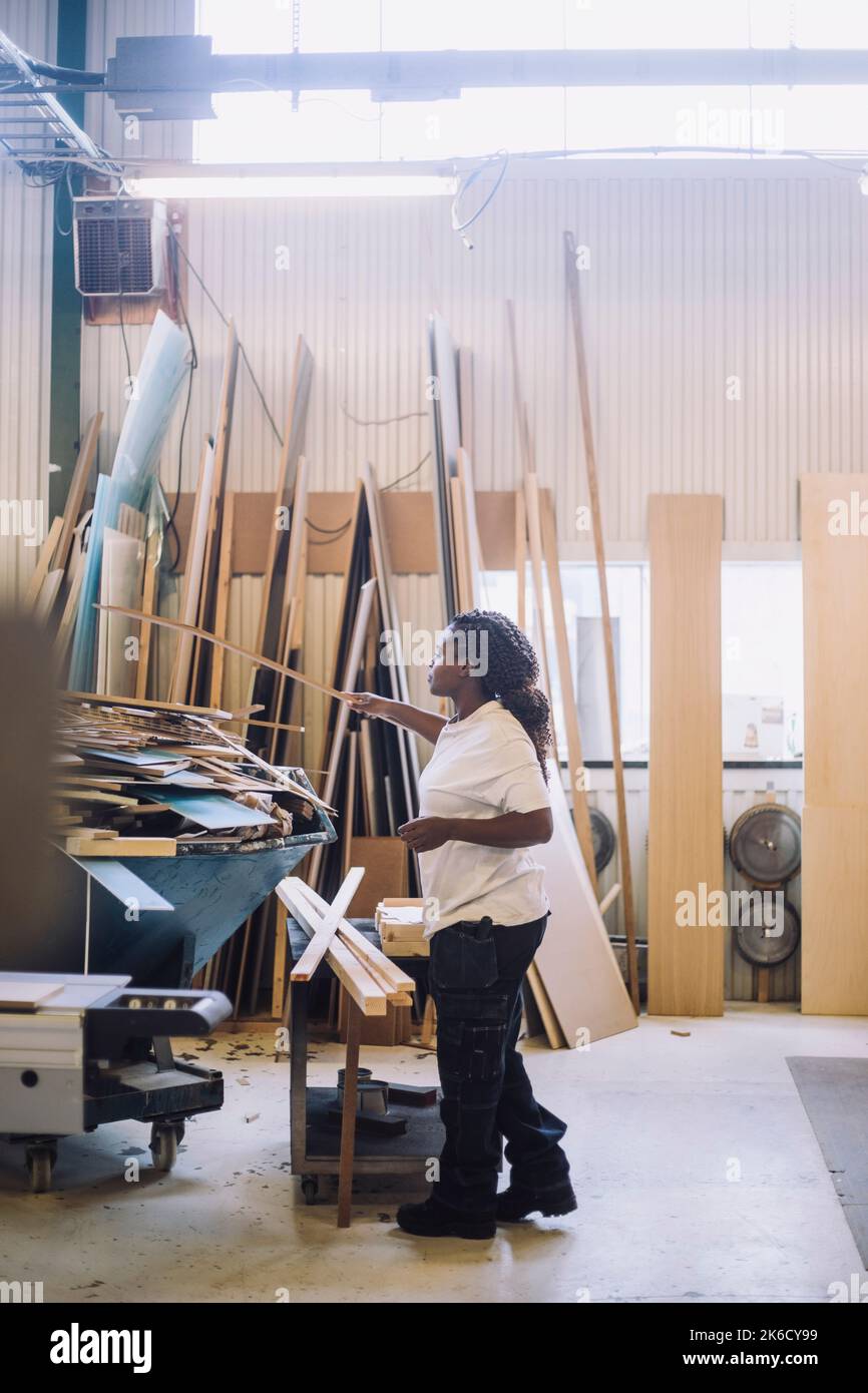Side view of female carpenter working in workshop Stock Photo - Alamy
